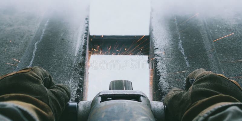 Worker Cuts Metal with Precision Tools while Sparks Fly in Industrial ...