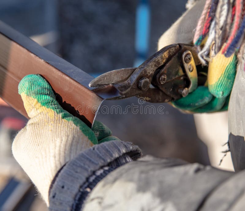 Worker Cuts Metal with Scissors at a Construction Site Stock Photo ...