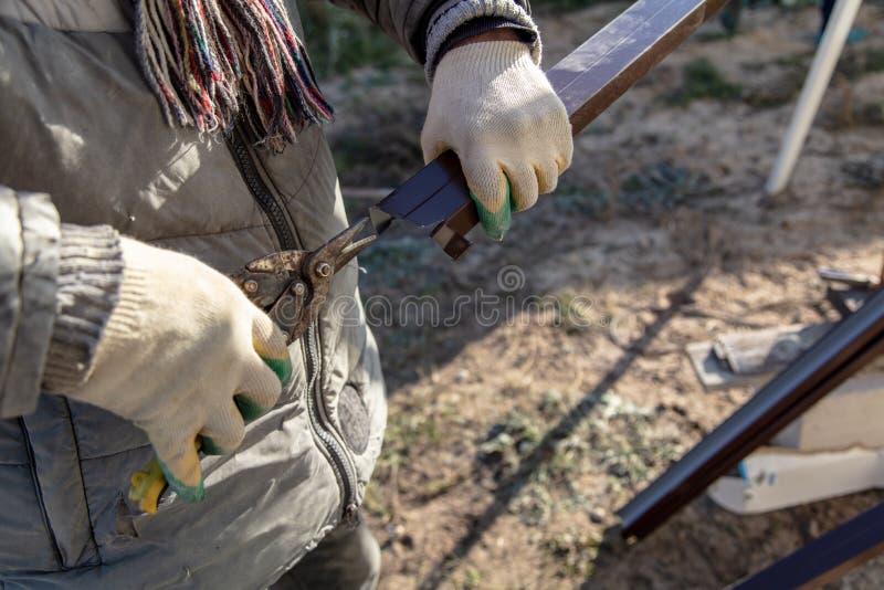 Worker Cuts Metal with Scissors at a Construction Site Stock Image ...