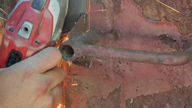 A Worker Cuts an Old Metal Lock with a Grinder. Sparks during Operation ...