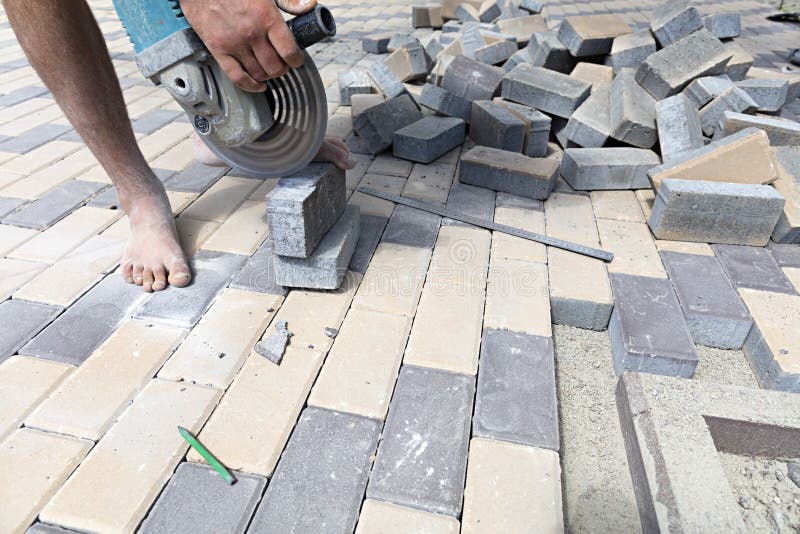 Worker Cuts Paving Slabs for Laying on the Sidewalk Stock Photo - Image ...