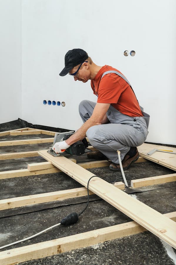 Worker Cuts Wooden Floorboards. Stock Image - Image of construction ...