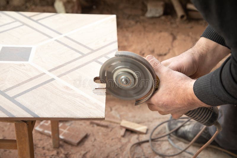Worker Cutting a Ceramic Tile with a Grinder Stock Photo - Image of ...