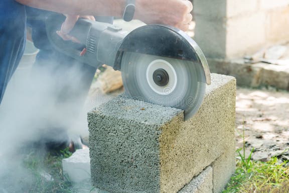 Worker Cutting Cinder Block with Angle Grinder Stock Photo - Image of ...