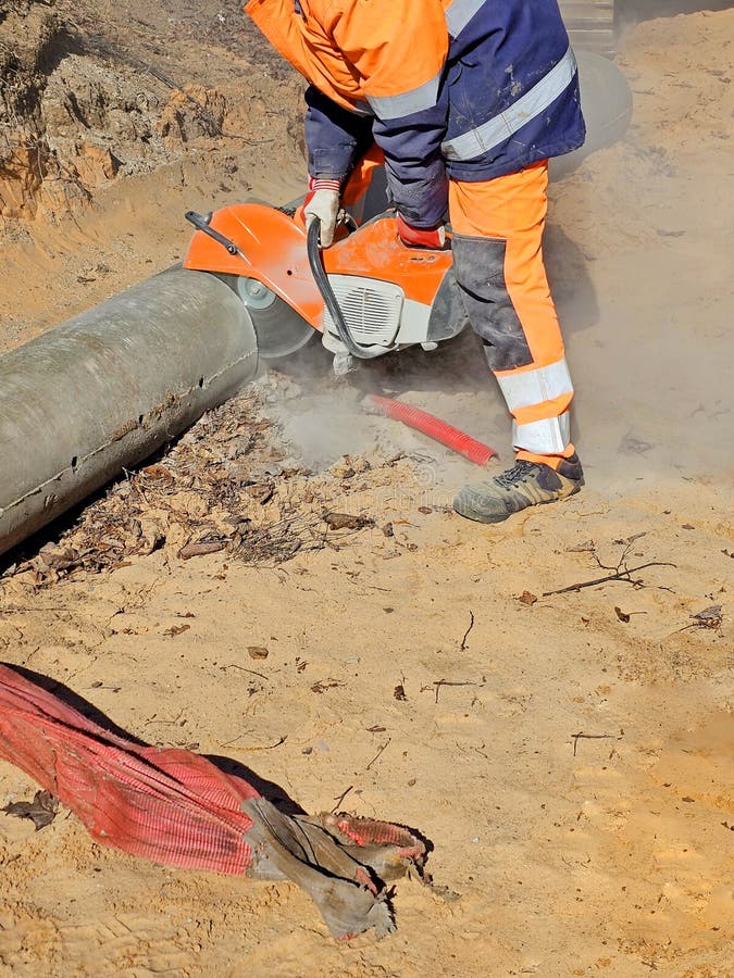Worker Cutting a Concrete Pipe at a Construction Site Stock Photo ...