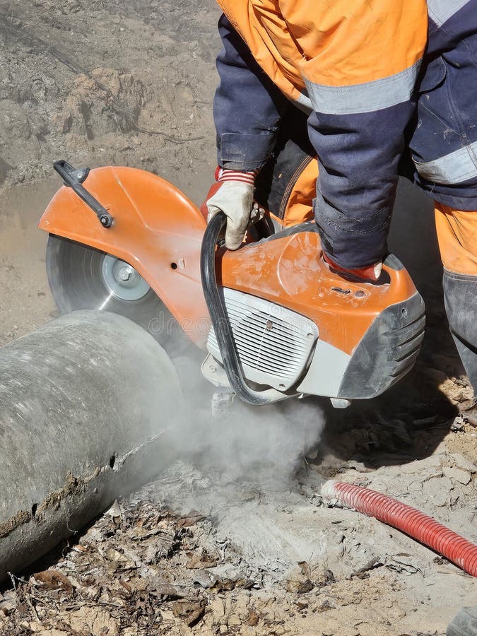 Worker Cutting a Concrete Pipe at a Construction Site Stock Image ...