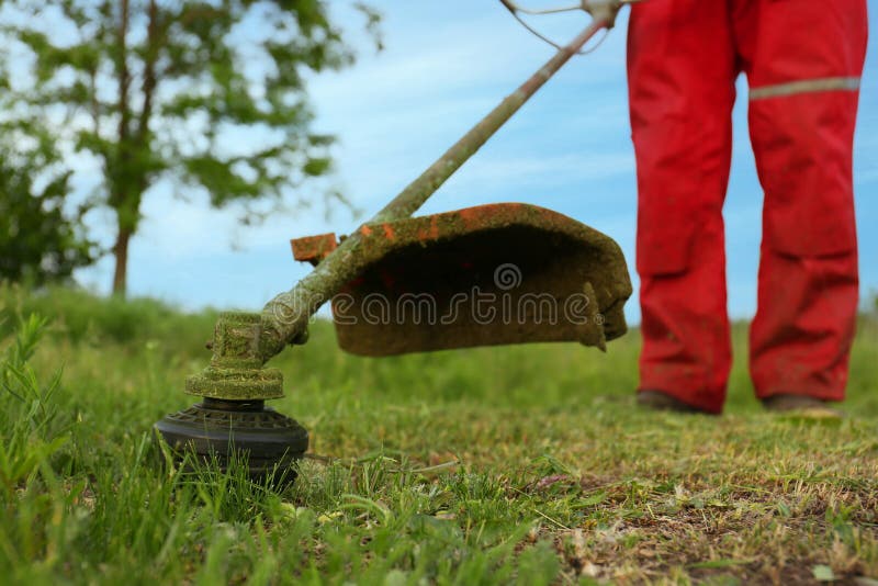 Worker Cutting Grass with String Trimmer Outdoors, Closeup View Stock ...