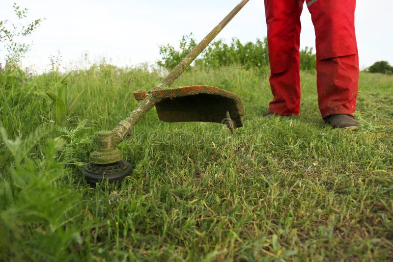 Worker Cutting Grass with String Trimmer Outdoors, Closeup View Stock ...
