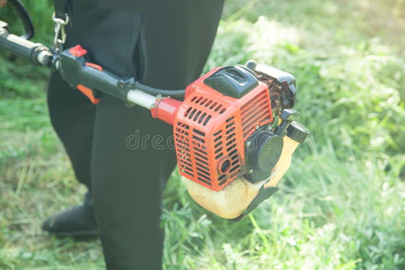 Worker Cutting Grass with a Grass Trimmer Stock Photo - Image of ...