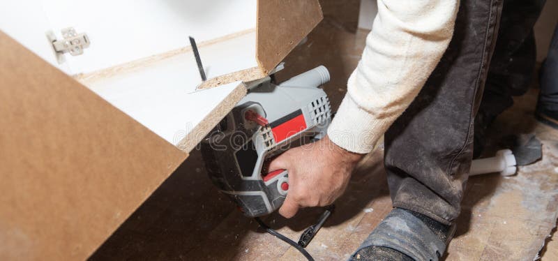 Worker Cutting Kitchen Cabinet Using Electric Saw Stock Image - Image ...