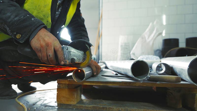 Worker Cutting Metal Pipe with Angle Grinder. a Close-up Shot of a ...
