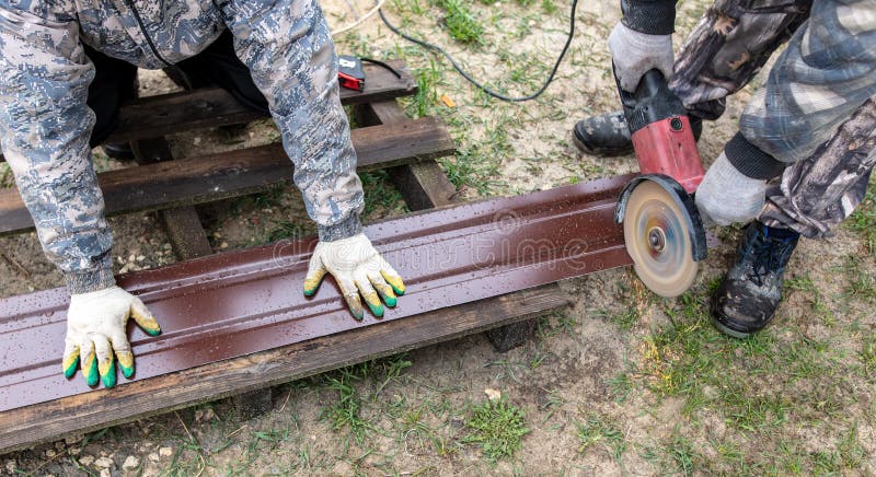 A Worker is Cutting Metal To Install a Fence Stock Image - Image of ...