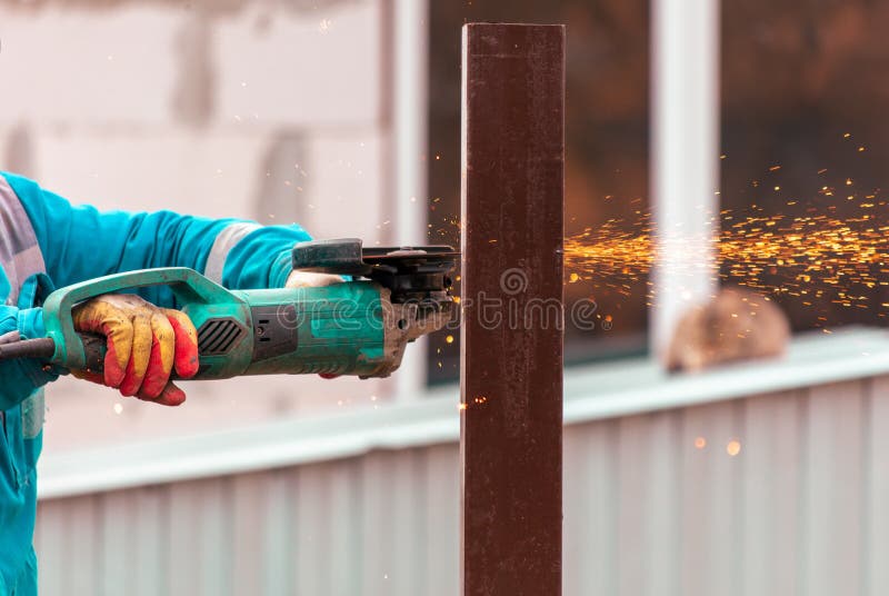 A Worker is Cutting Metal To Install a Fence Stock Image - Image of ...