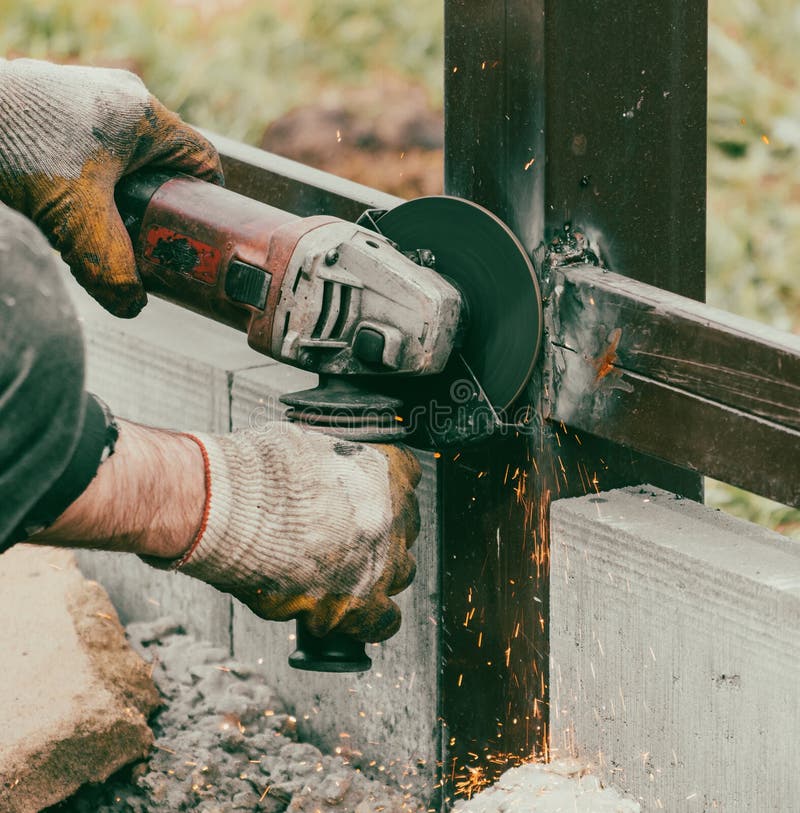 A Worker is Cutting Metal To Install a Fence Stock Image - Image of ...
