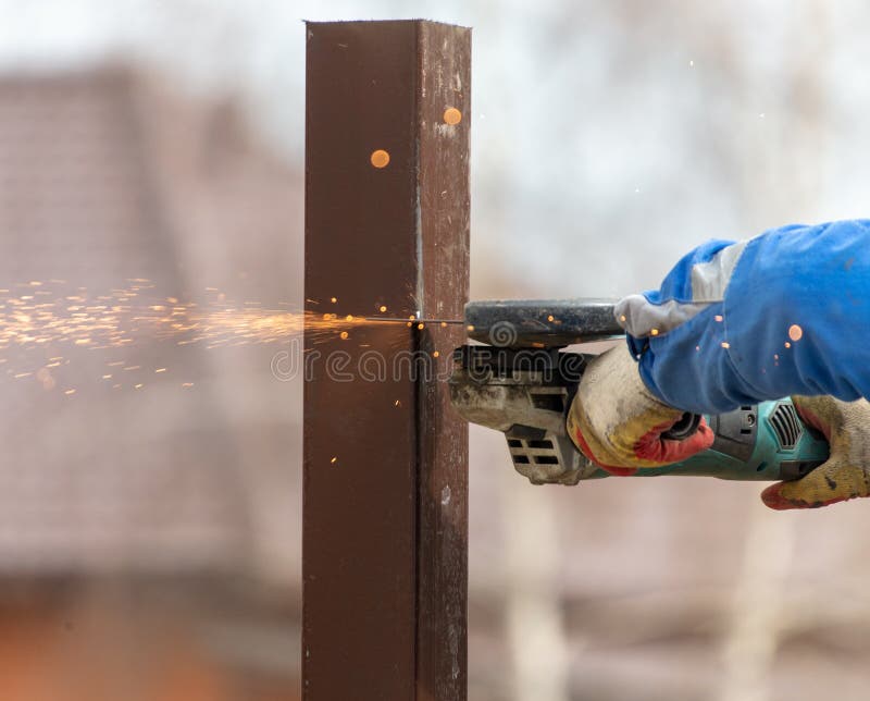 A Worker is Cutting Metal To Install a Fence Stock Photo - Image of ...