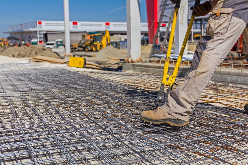 Worker is Cutting Rebar with Scissors for Reinforcement Bars. Stock ...