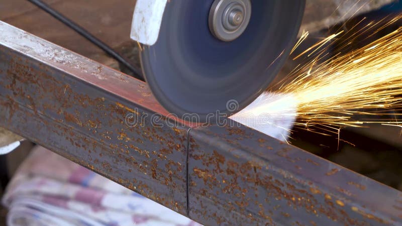Worker Cutting Rectangular Steel Tube with an Angle Grinder Tool ...
