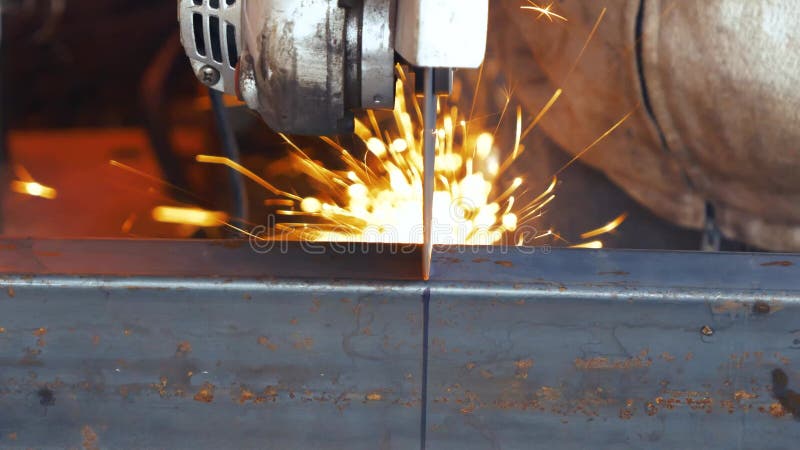 Worker Cutting Rectangular Steel Tube with an Angle Grinder Tool ...