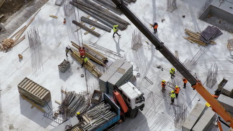 Worker Waiting for a Coming Down Hook Crane on a Truck at the ...
