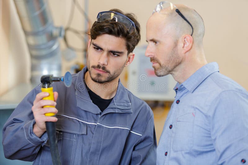 Worker Deciding on Tool in Workshop Stock Photo - Image of pipe, object ...