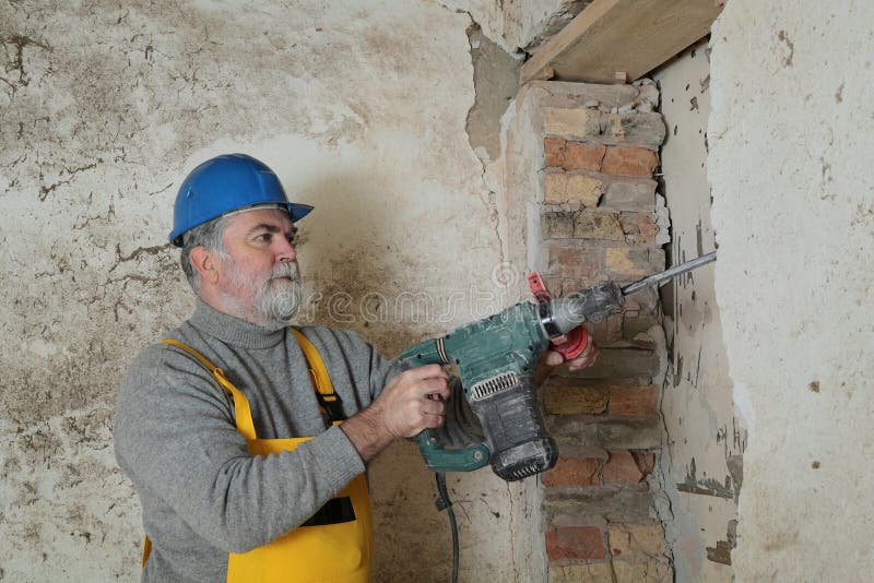 Worker demolish brick wall stock image. Image of breaker - 167283041