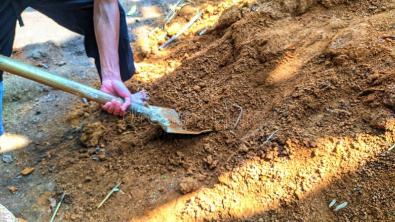 A Worker is Digging at the Garden Stock Photo - Image of sand, person ...