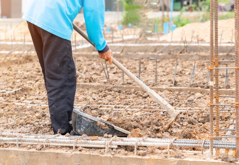 A Worker Digging the Ground with Spade in Construction Site Stock Photo ...