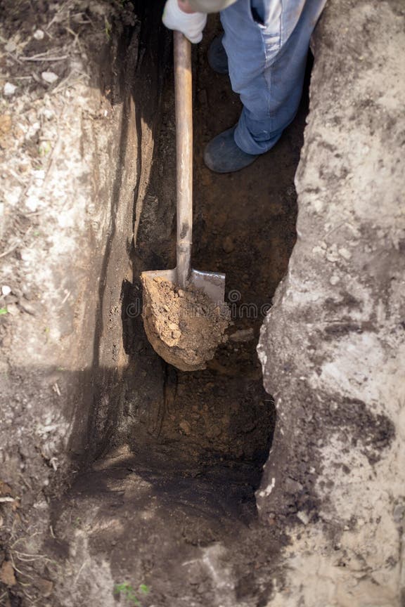 A Worker Digs a Pit with a Shovel on a Construction Site Stock Image ...