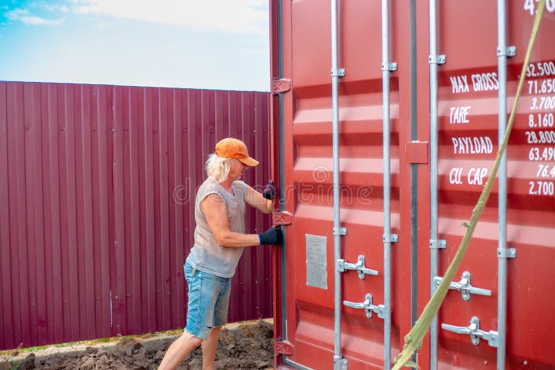 A Worker Directs a Cargo Container Being Lowered into Place at Its ...