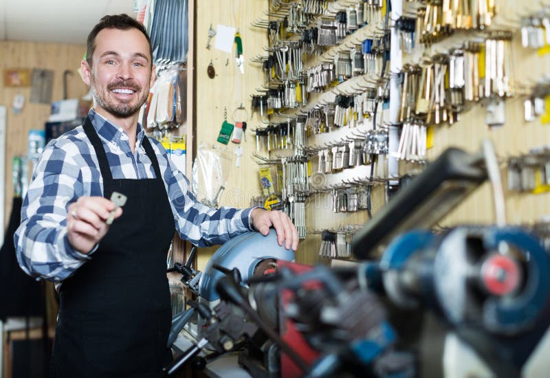 Worker Displaying Result of His Key Making in Workplace Stock Photo ...