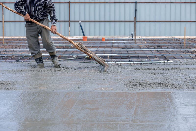 Worker Disposes of the Liquid Concrete Along the Reinforcement Stock ...