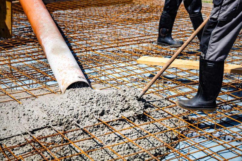 Worker Distributing Concrete Onto Rebar Framework for Slab Foundation ...