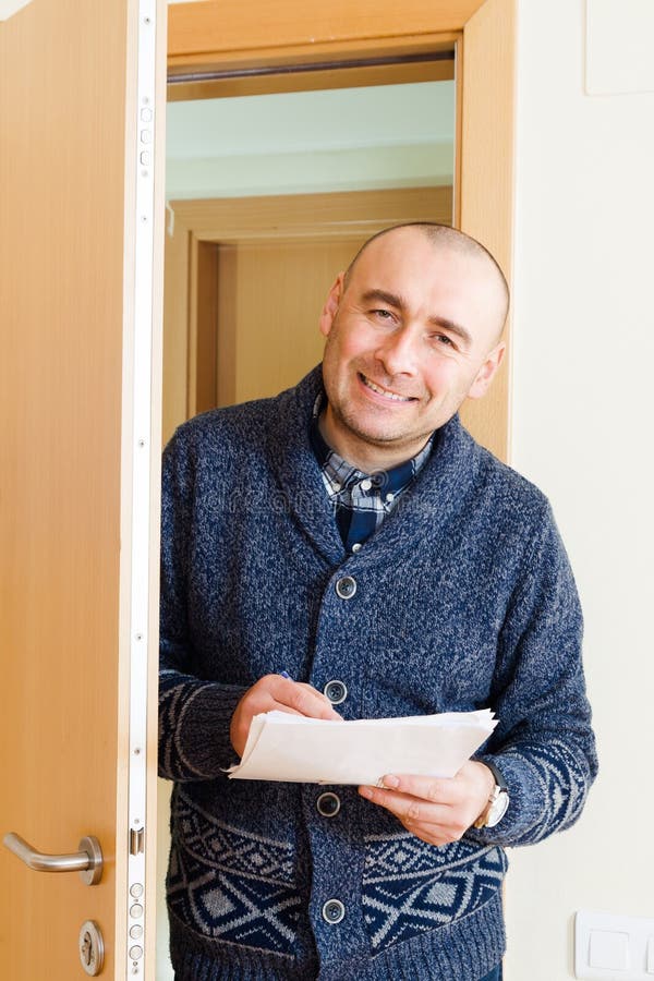 Worker with Documents in Doorway Stock Image - Image of survey ...