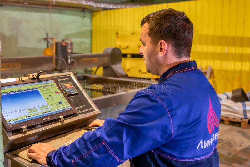 A Worker Does the Setting Up of a Waterjet Machine. the Operator ...