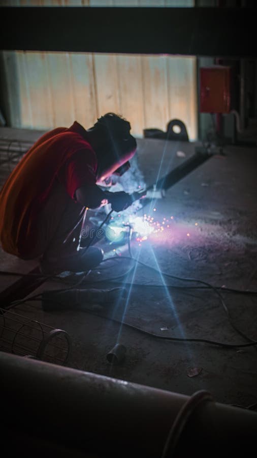A Worker Doing Fabrication Work Stock Image - Image of music, blue ...