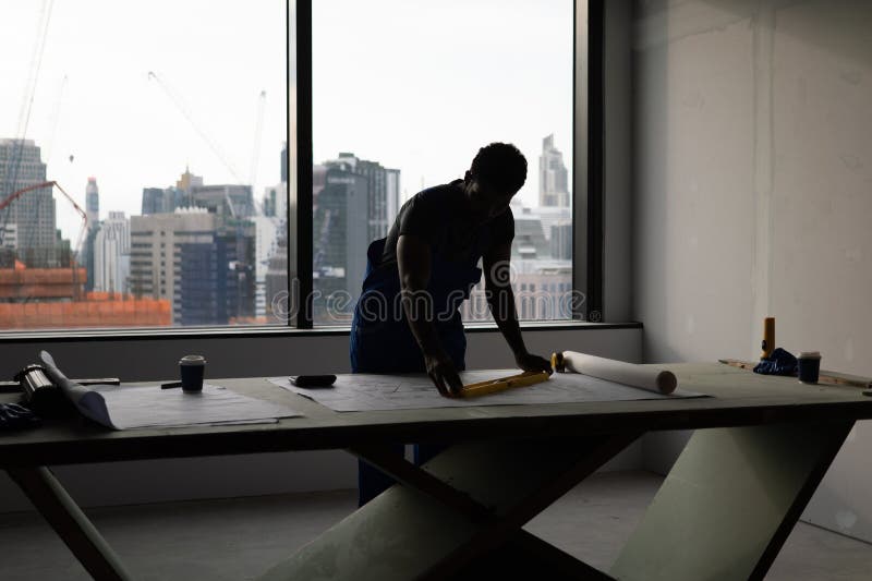 Worker with Drawing on Blueprint of Architectural Project Plan on ...