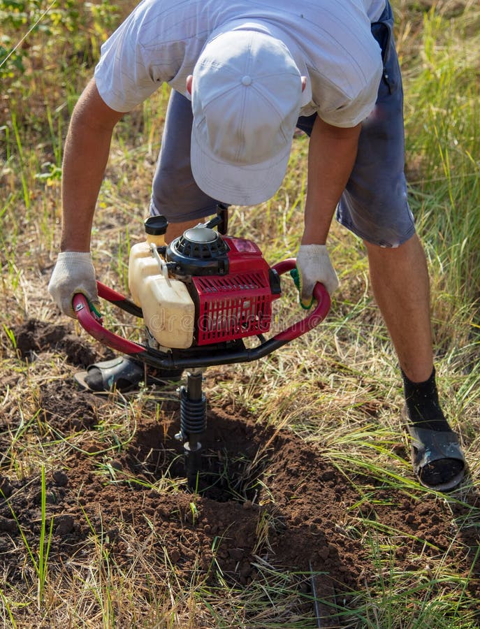 Ground Worker Working At Nighttime In The Dark With A Digger Machine ...