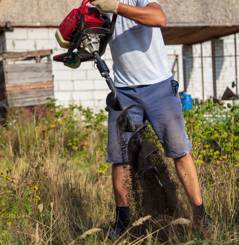 Worker Drills the Ground for the Fence Stock Image - Image of power ...