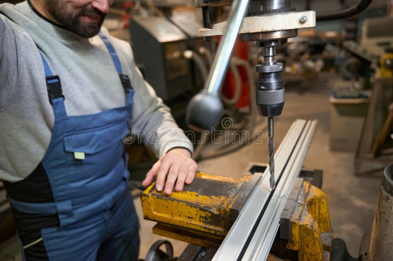 Worker Drills a Hole into Aluminum Profile on Modern Machine Stock ...