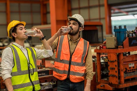 Worker Drinking Water in Factory Site. Stock Photo - Image of inspector ...