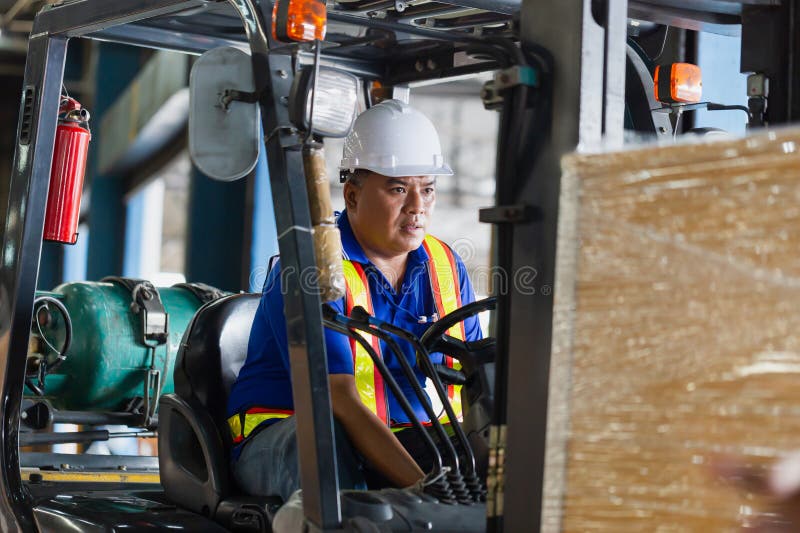 Worker Driver at Warehouse Forklift Loader Works To Containers Box ...