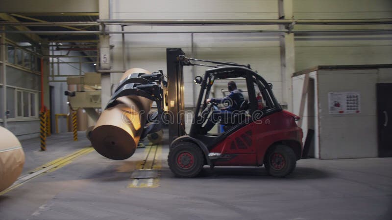 Worker Drives Forklift Loader Carrying Paper Roll in Storage Stock ...