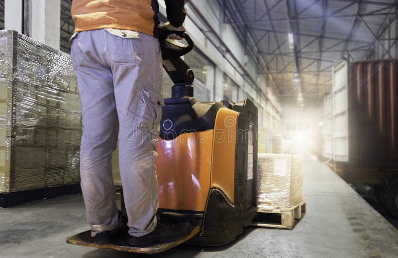 Worker Driving Electric Forklift Pallet Jack Loading Package Boxes into ...