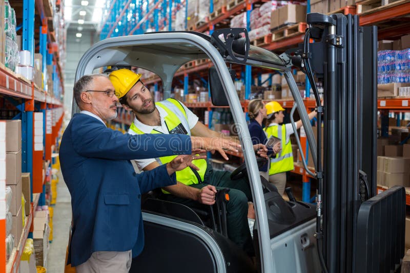 Worker Driving Forklift Discussing with Businessman Stock Image - Image ...