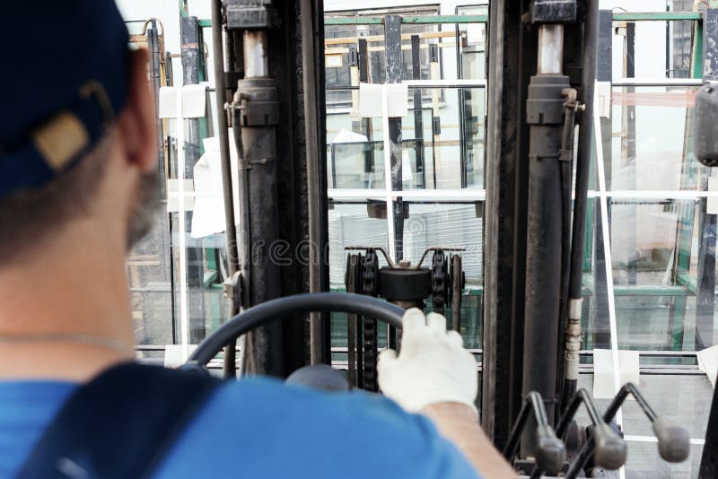 Worker Driving Forklift and Loading Glass Constructions Stock Image ...