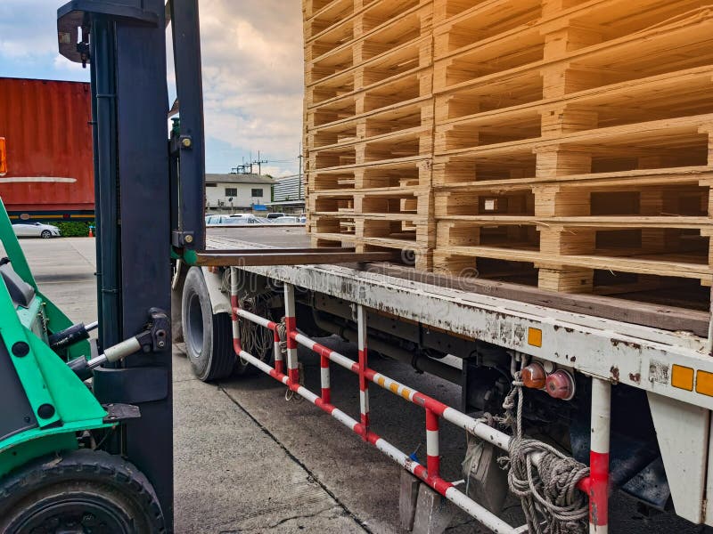 Worker Driving Forklift To Loading and Unloading Wooden Pallets from ...