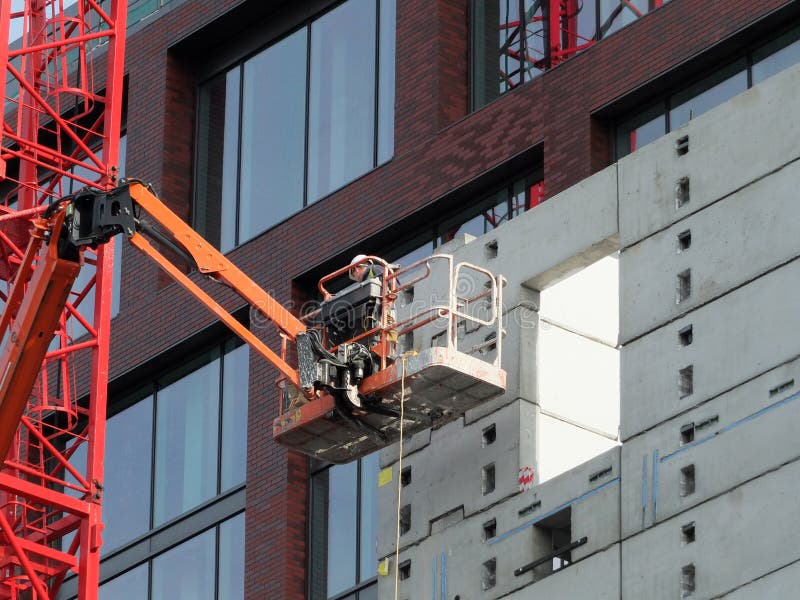 Worker on an Elevated Construction Platform on Modern Building D Stock ...
