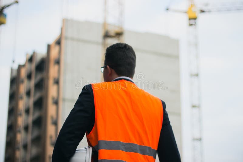 The Engineer Holding The White Helmet Safety At Construction Site With ... The Engineer Holding The White Helmet Safety At Construction Site With ...