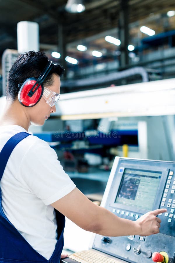 Worker Entering Data in CNC Machine at Factory Stock Image - Image of ...