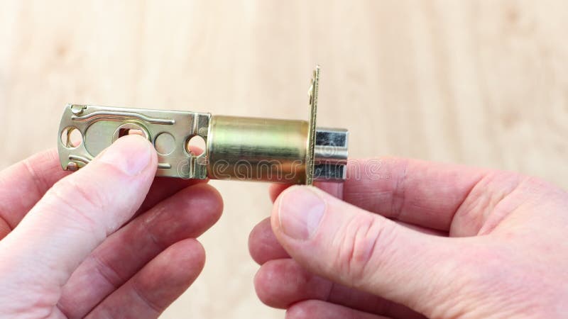 Locksmith Holds Door Latch Mechanism, Carefully Checking Operation of ...